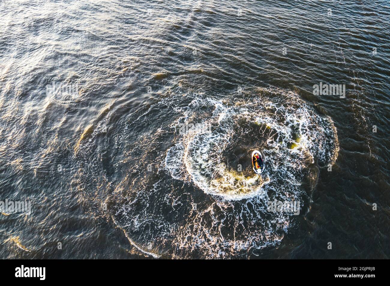 Aerial view of Young man making circle loop riding on fast water ...