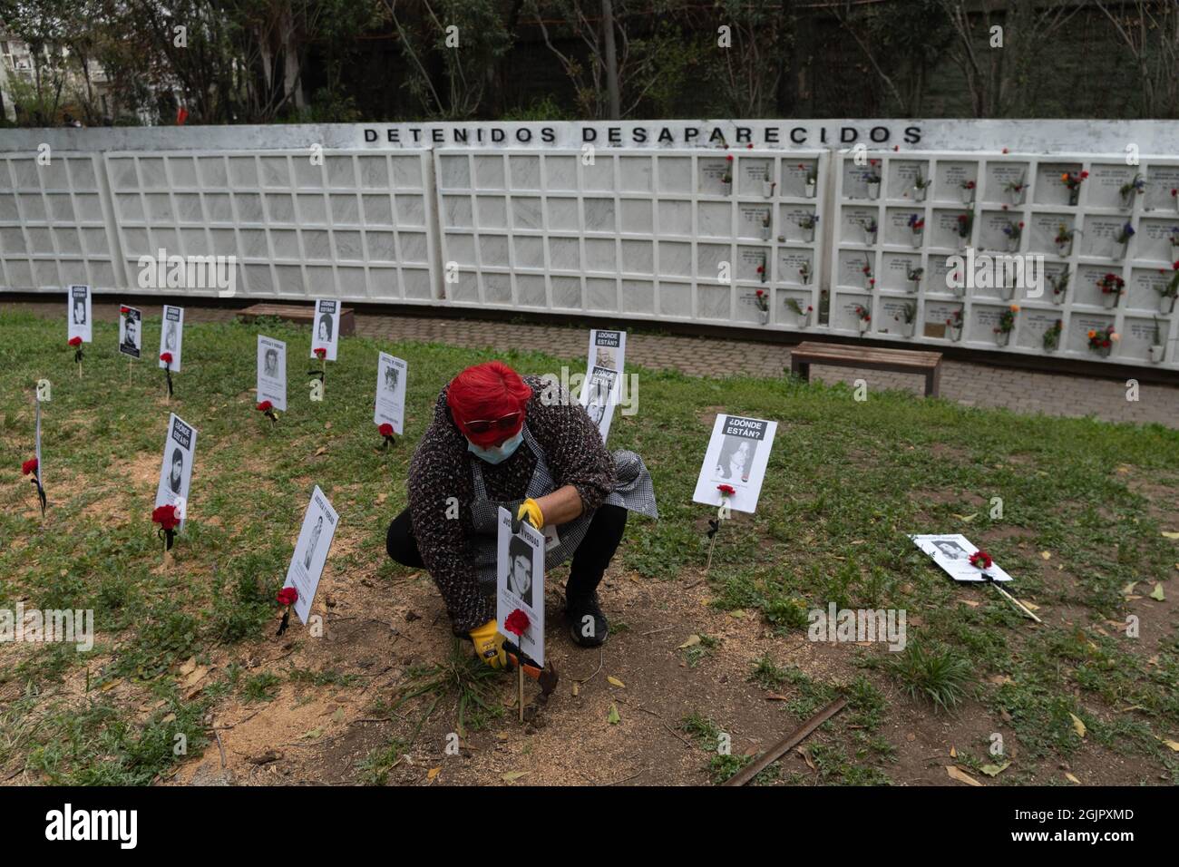 Santiago, Metropolitana, Chile. 11th Sep, 2021. A woman places some ...