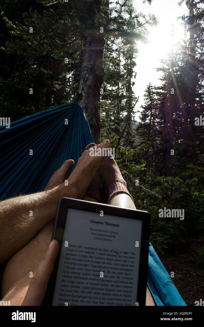 Reading in the hammock Stock Photo - Alamy
