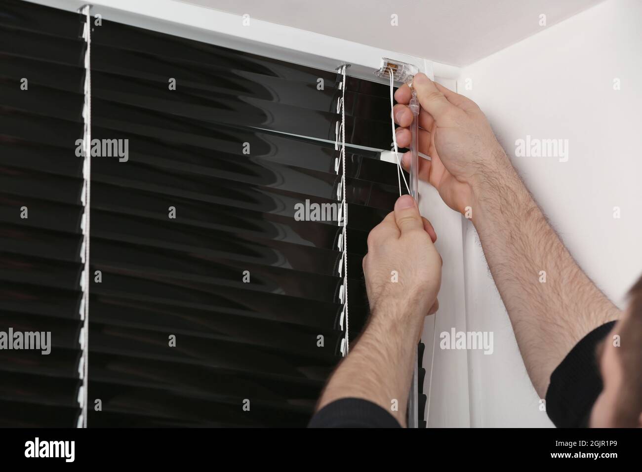 Male hands installing window blinds Stock Photo - Alamy