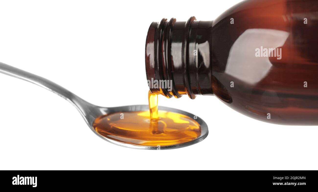 Pouring cough medicine syrup into spoon on white background Stock Photo ...
