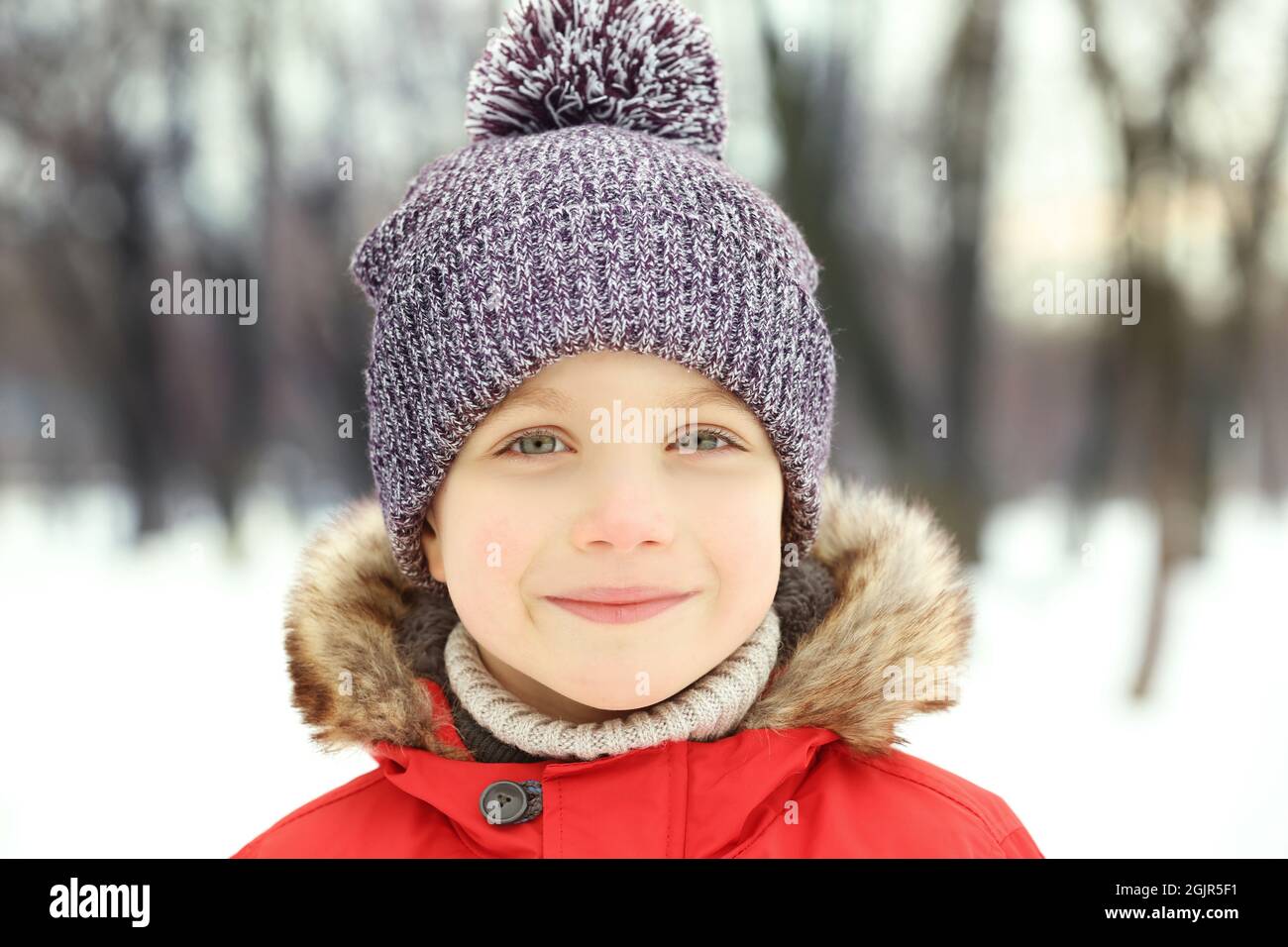 Portrait of cute smiling boy in beautiful warm outfit on winter ...