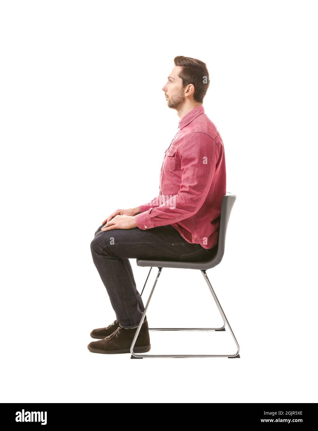 Incorrect posture concept. Man sitting on chair isolated on white Stock ...