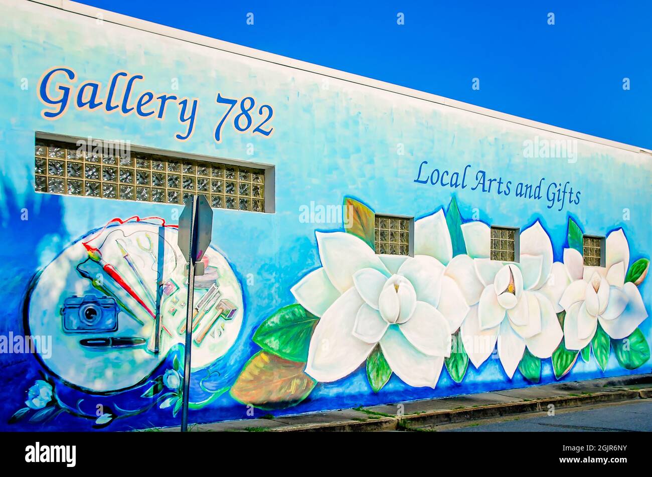 A mural of magnolias is painted on the side of the Pringle Building ...