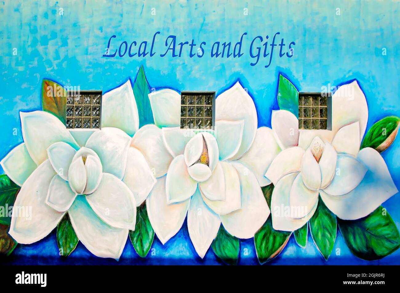 A mural of magnolias is painted on the side of the Pringle Building ...