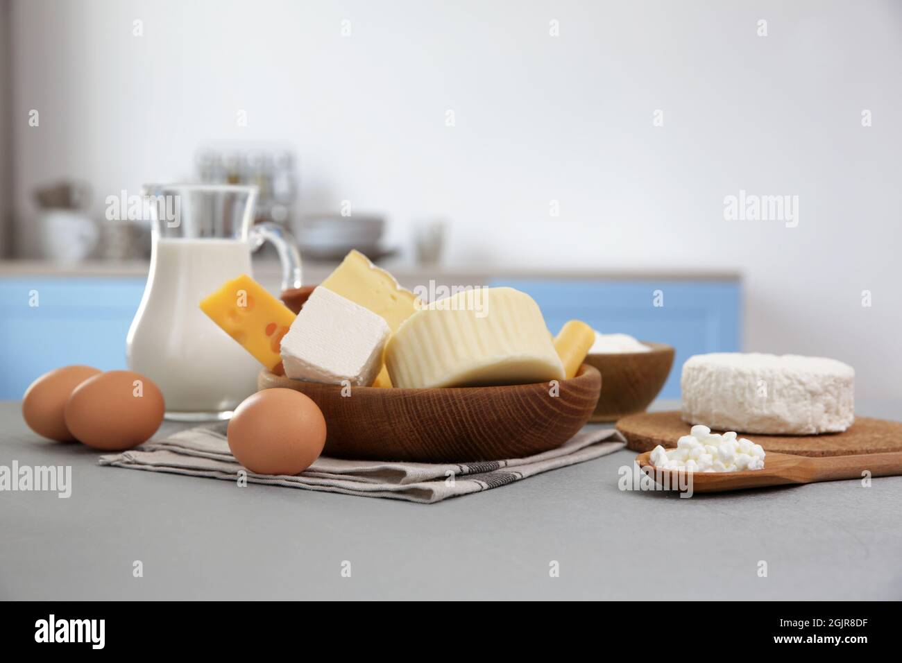 Different dairy products on kitchen table Stock Photo - Alamy