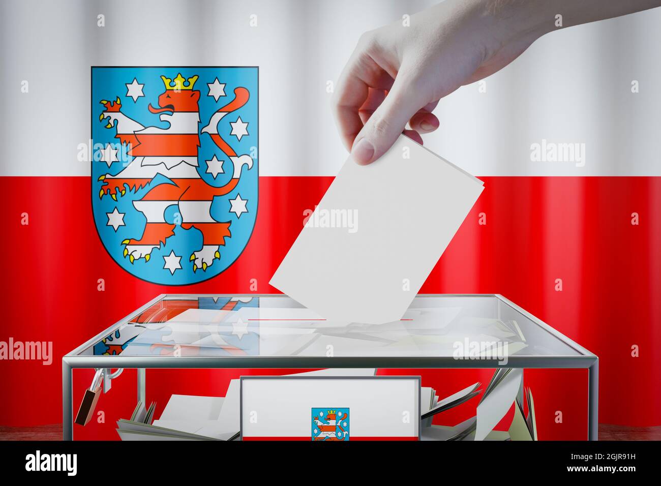 Thuringia flag, hand dropping ballot card into a box - voting/ election ...