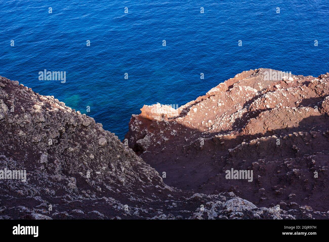 View of the scenic lava rock cliff in the Linosa island. Sicily Stock ...