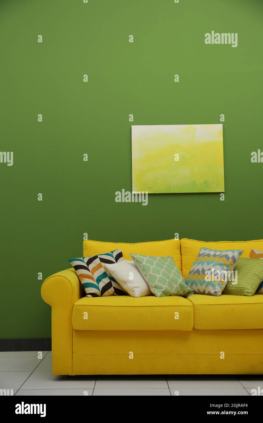 Room interior with sofa on color wall background Stock Photo - Alamy