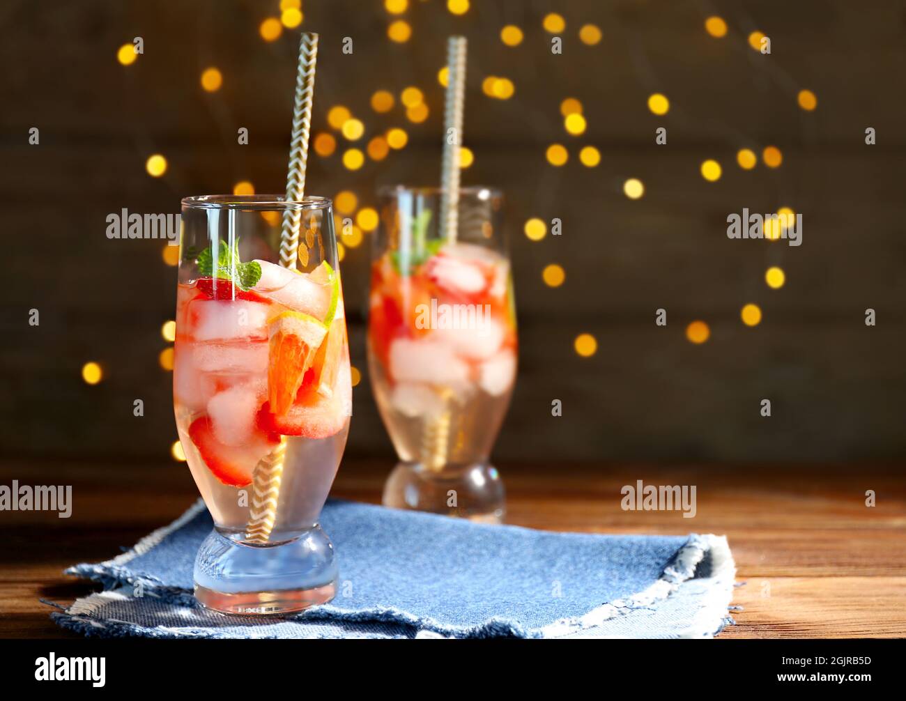 Glass of delicious wine spritzer on blurred lights background Stock ...