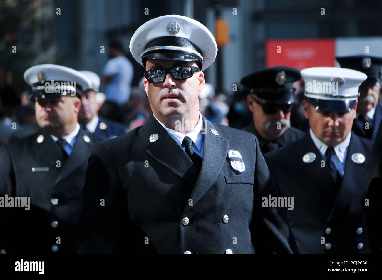 Uniformed NYPD and NYFD officers march through the streets on the 20th ...