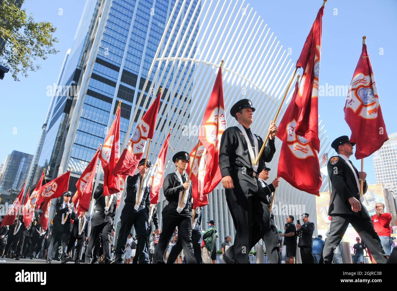 Uniformed NYPD and NYFD officers march through the streets while ...