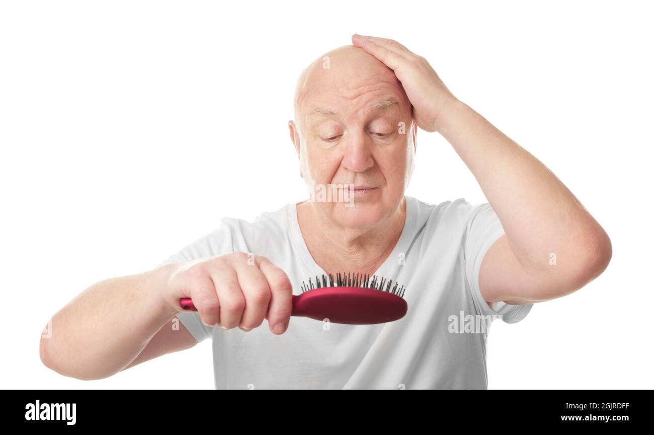 Bald senior man with hair brush on white background Stock Photo - Alamy