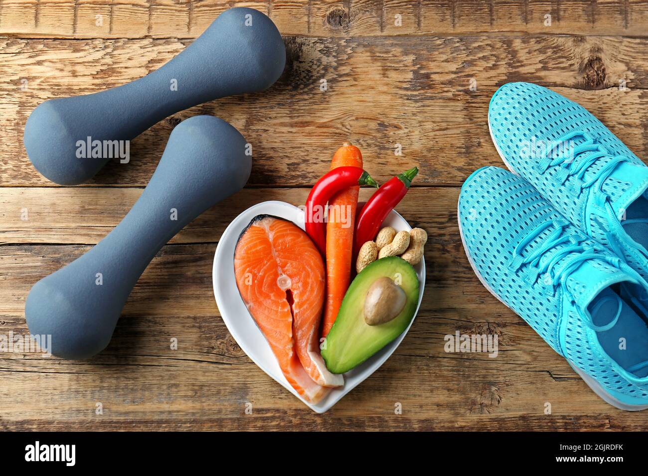 Healthy food and dumbbells on wooden background Stock Photo - Alamy