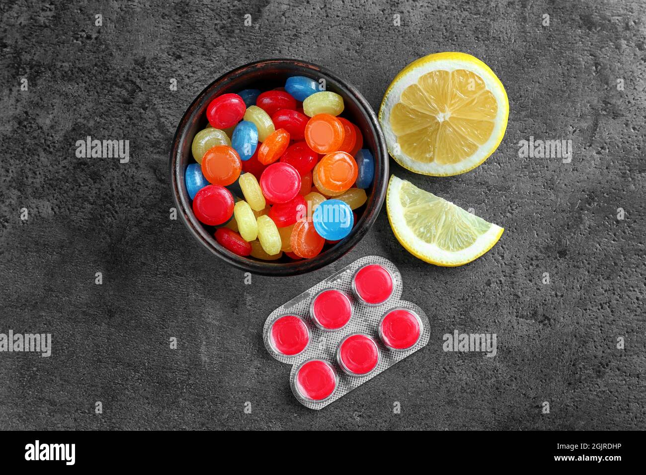 Different cough drops with lemon on grey background Stock Photo - Alamy
