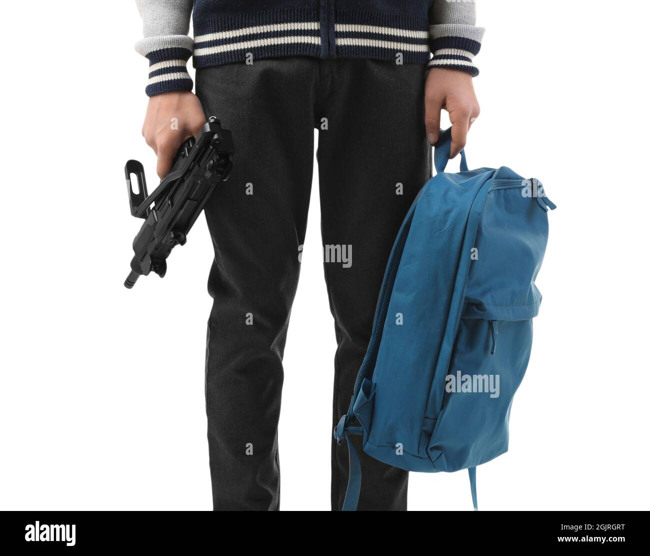 Teenage boy with backpack holding gun on white background Stock Photo ...