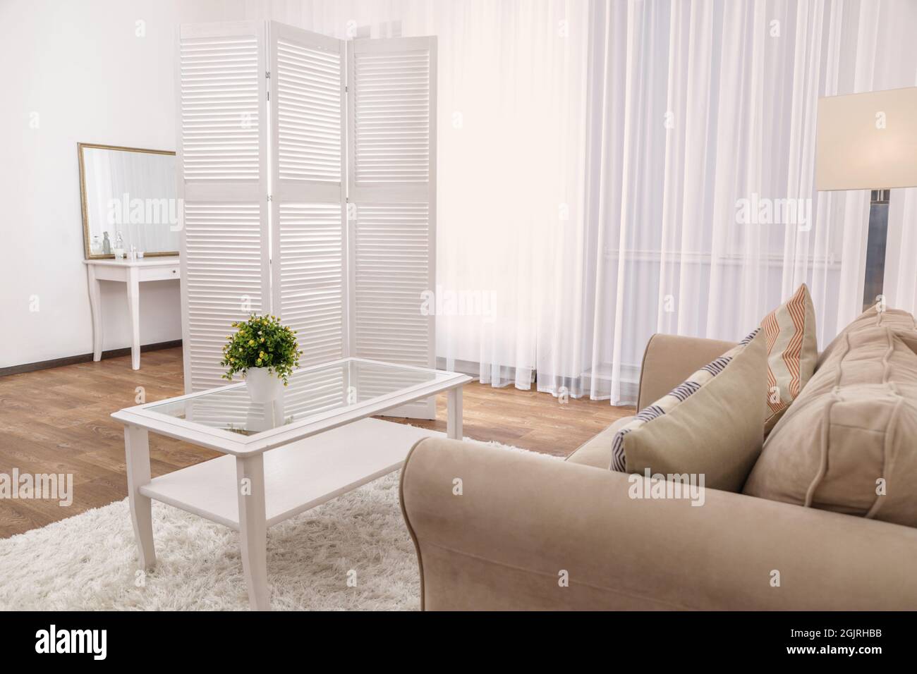 Interior of beautiful living room with folding screen and sofa Stock ...
