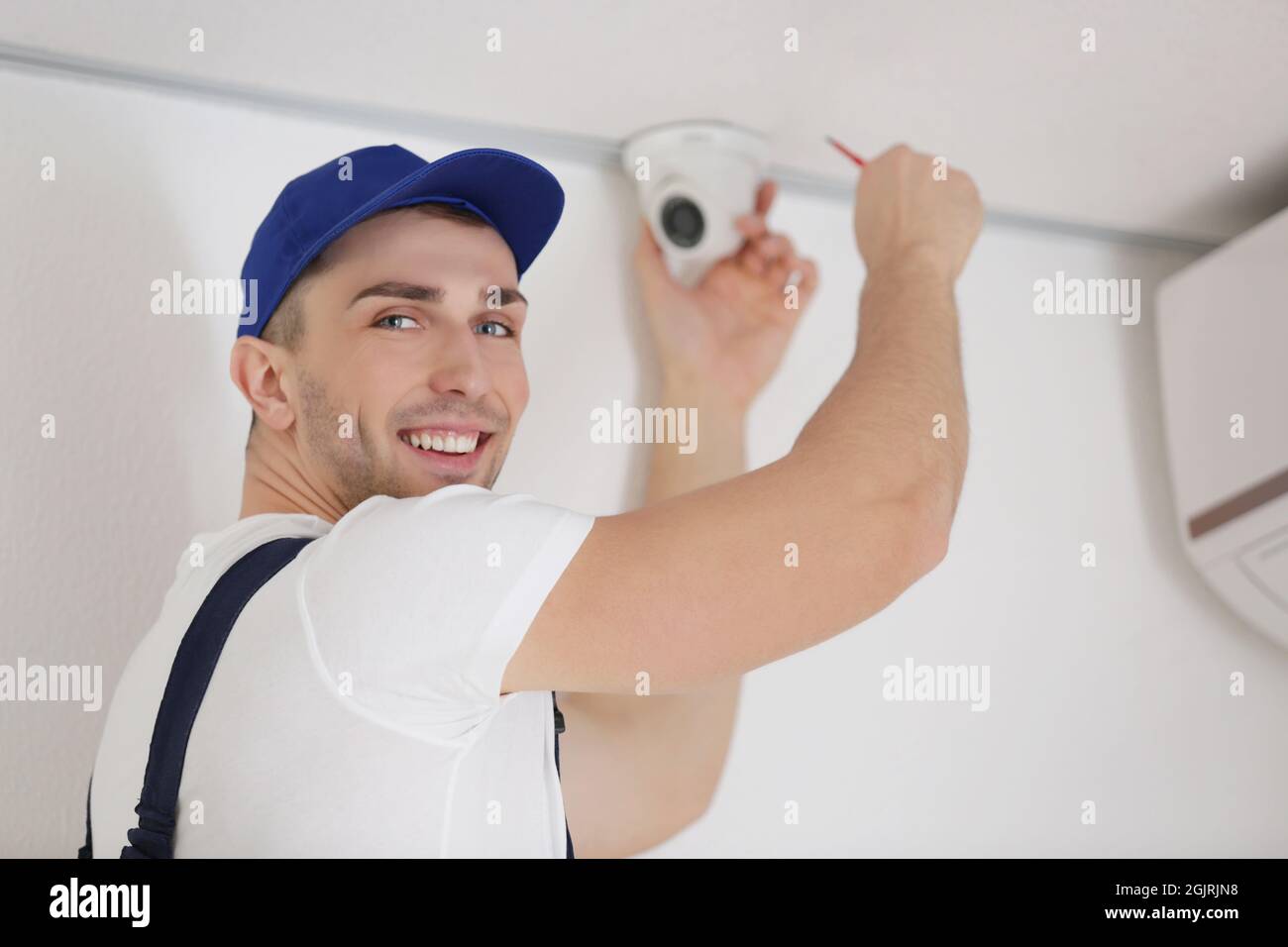 Technician fixing video surveillance camera Stock Photo - Alamy