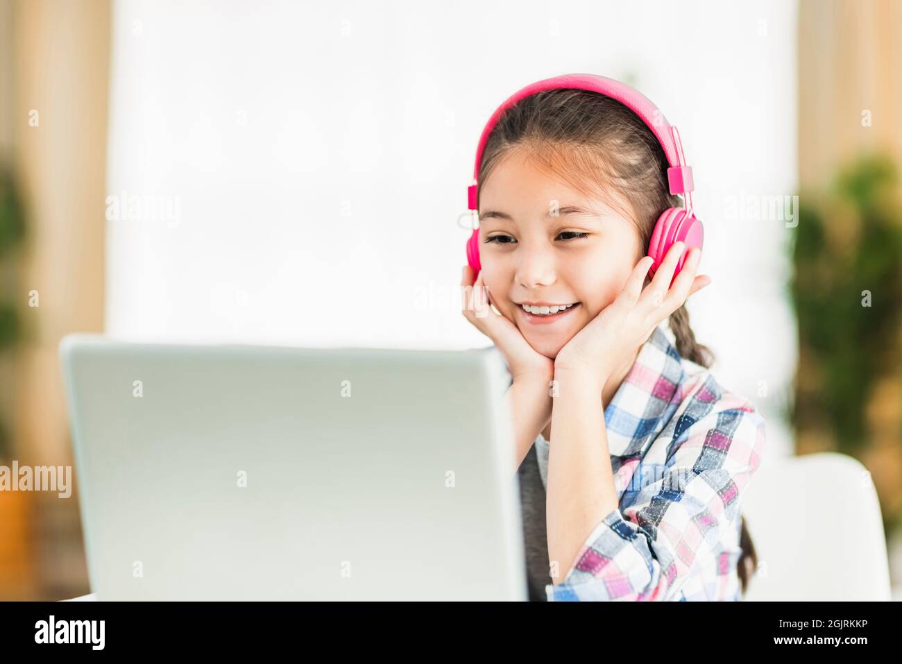 Happy student girl in headphones.Study online on laptop listening ...