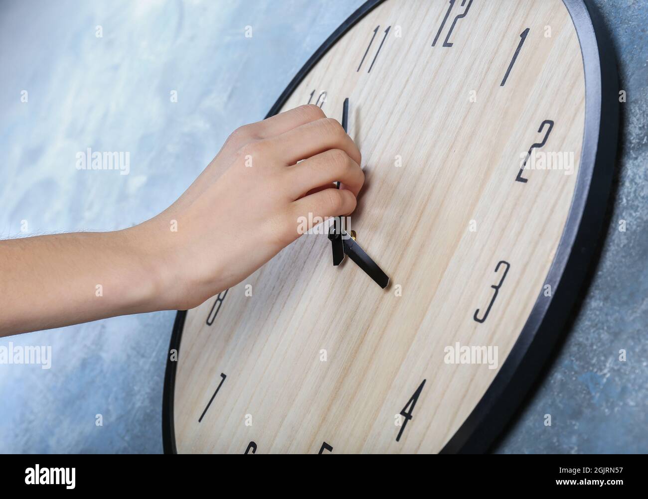 Female hand change time on big wall clock Stock Photo - Alamy