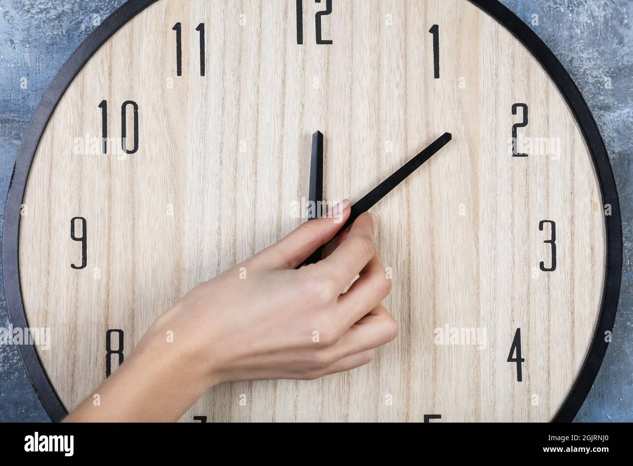 Female hand change time on big wall clock Stock Photo - Alamy