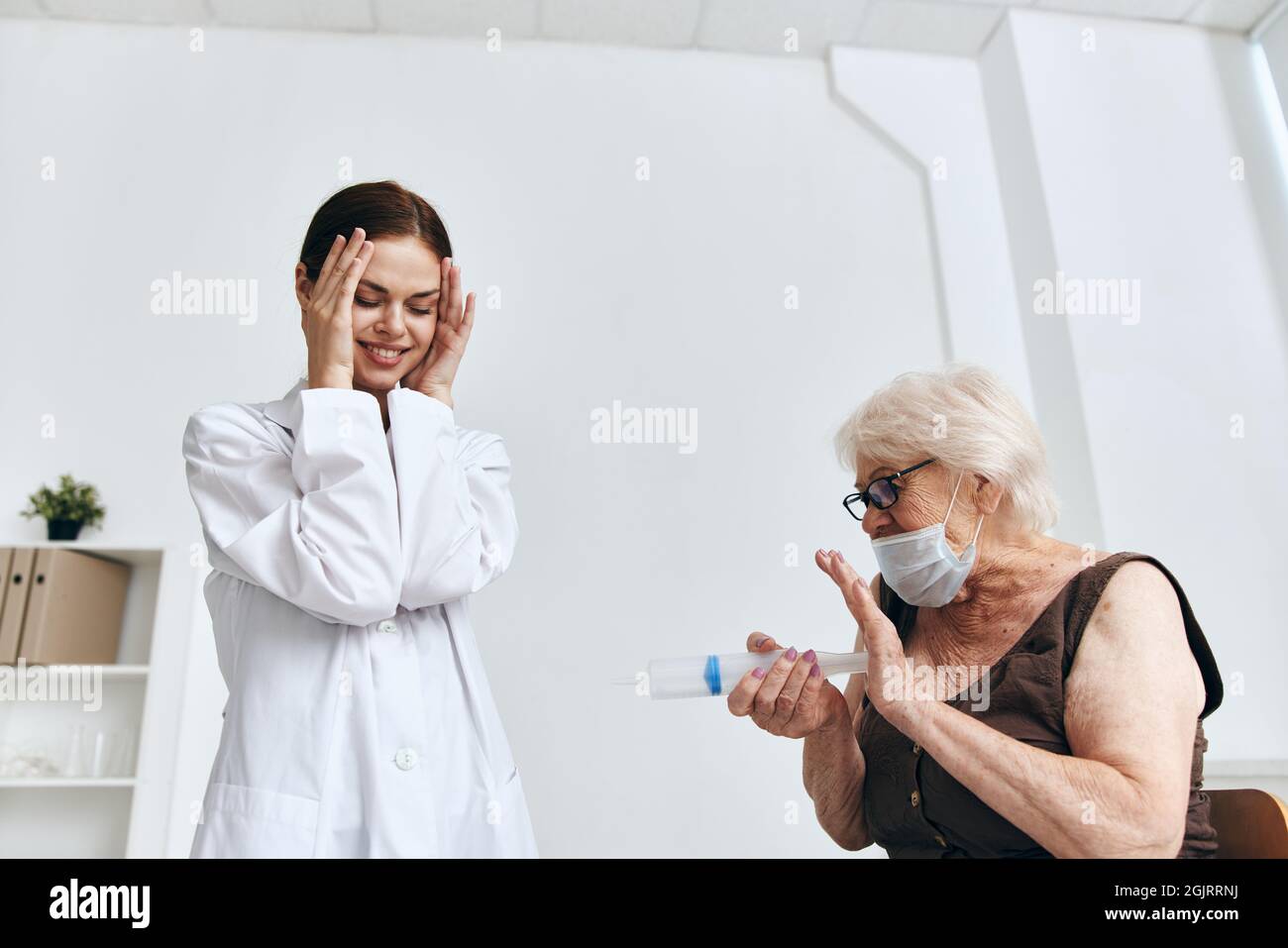 Emotional Nurse And Patient Syringe Injection Fun Stock Photo - Alamy