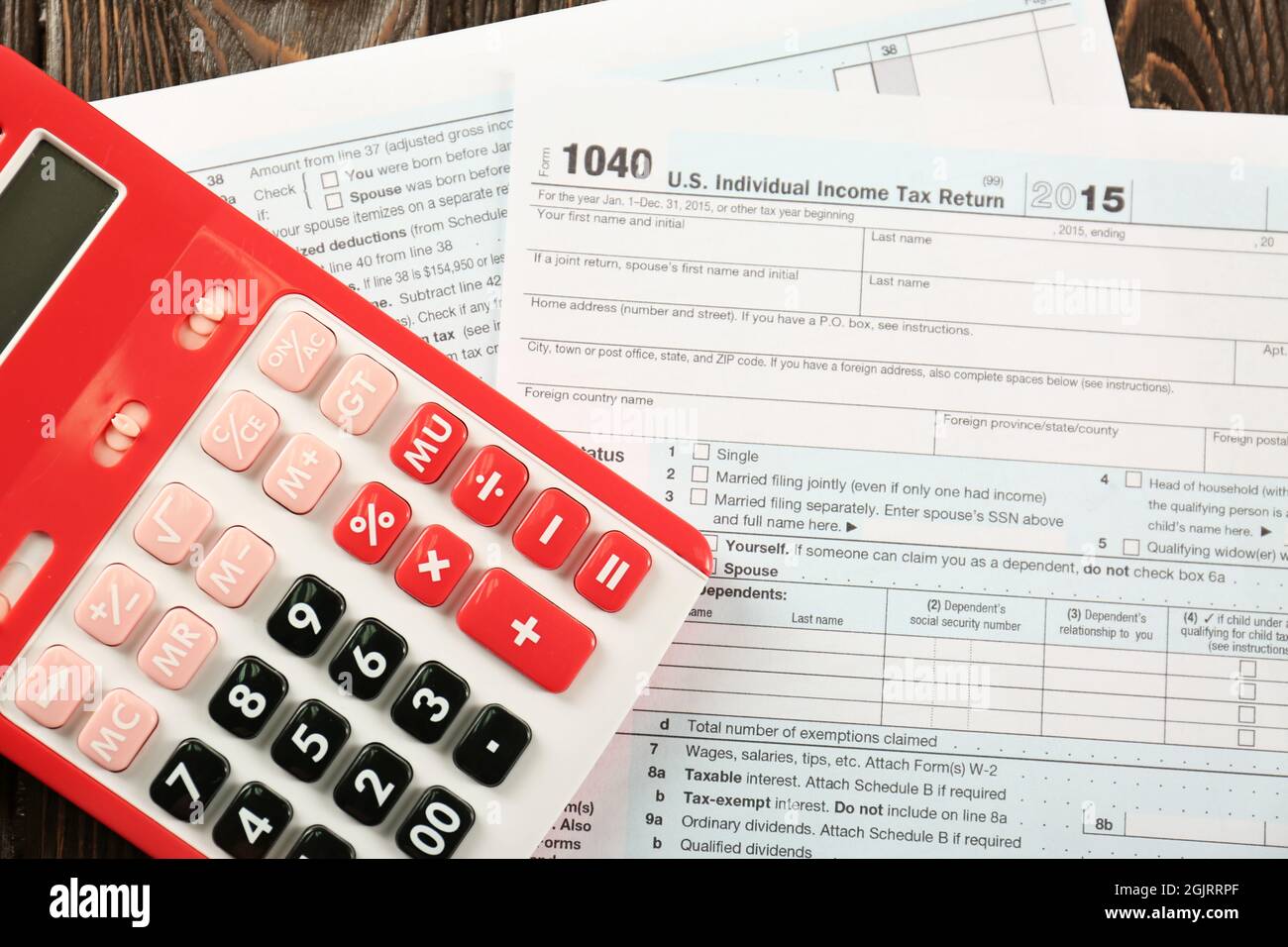 Calculator and individual income tax return form on table Stock Photo ...