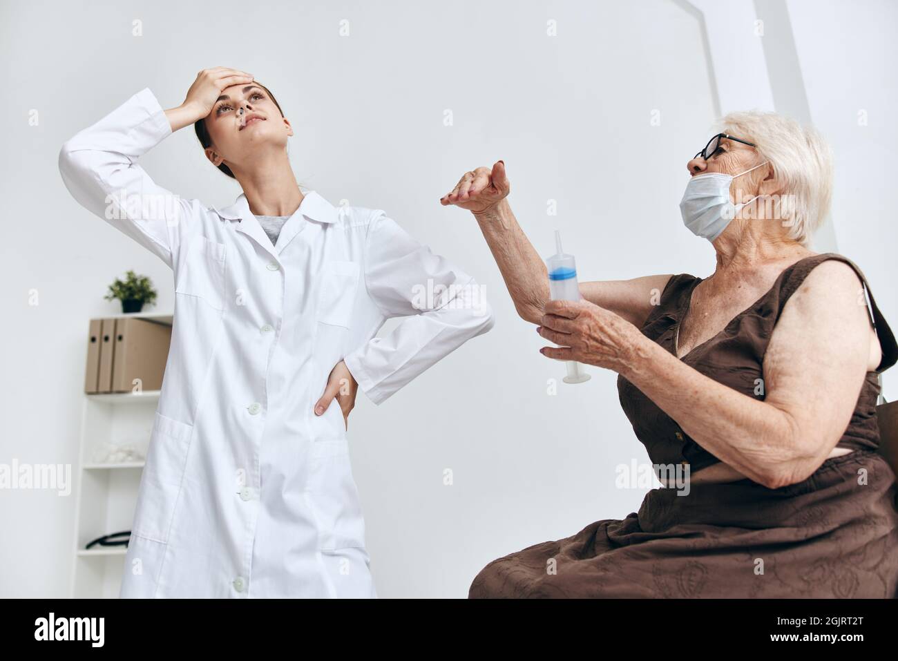 emotional elderly woman syringe injection immunity protection Stock ...