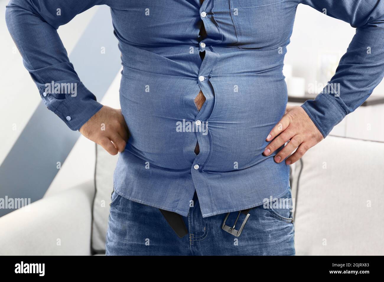 Man with big beer belly at home Stock Photo - Alamy