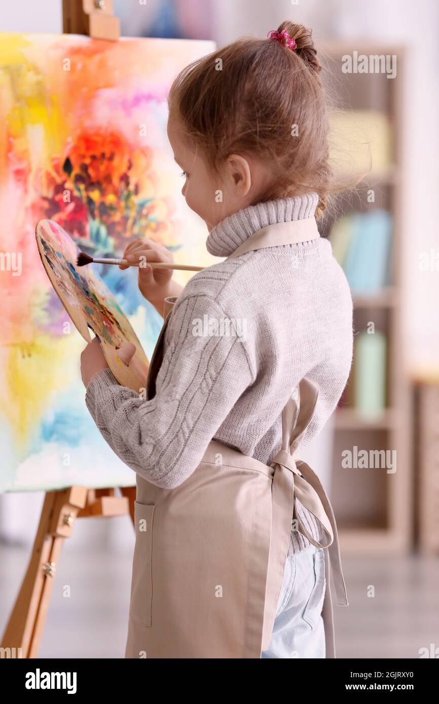 Cute little artist painting picture in studio Stock Photo - Alamy