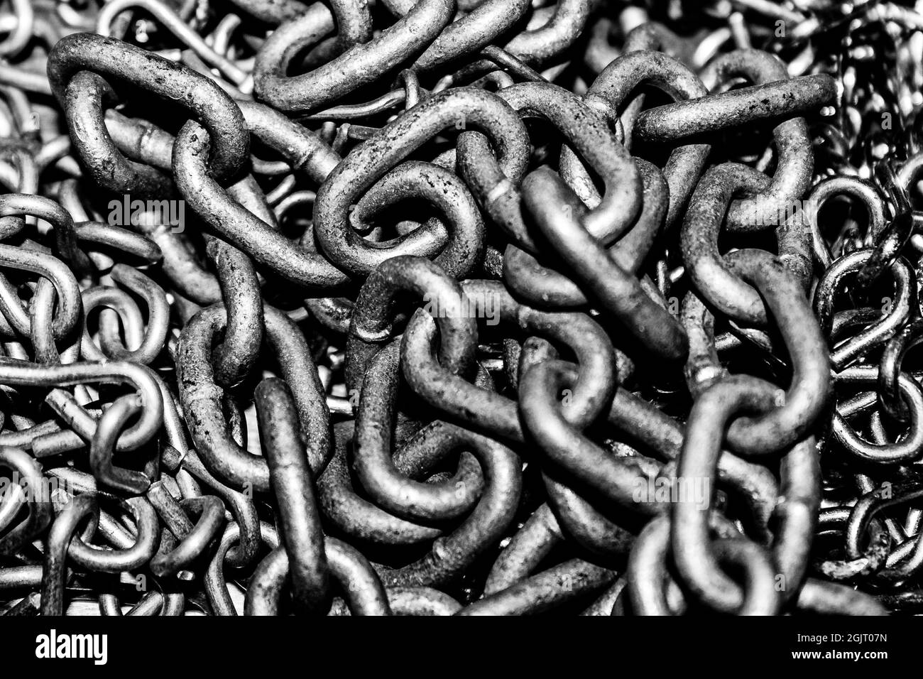 Pile of chains linked together in high contrast black and white Stock ...