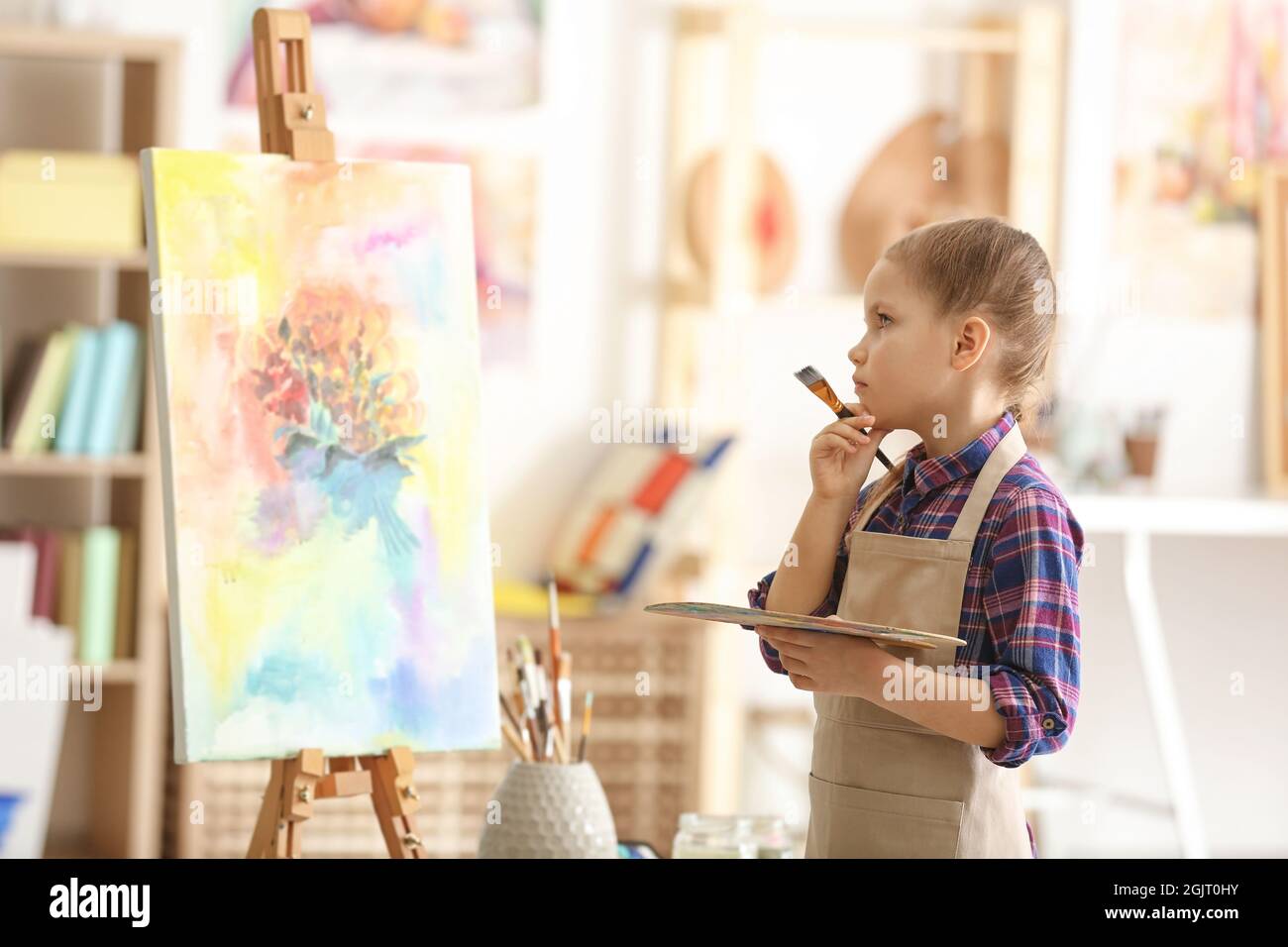 Cute little artist painting picture in studio Stock Photo - Alamy