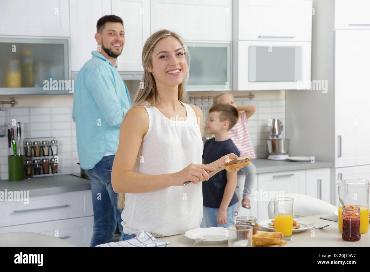 Happy family having breakfast on kitchen Stock Photo - Alamy