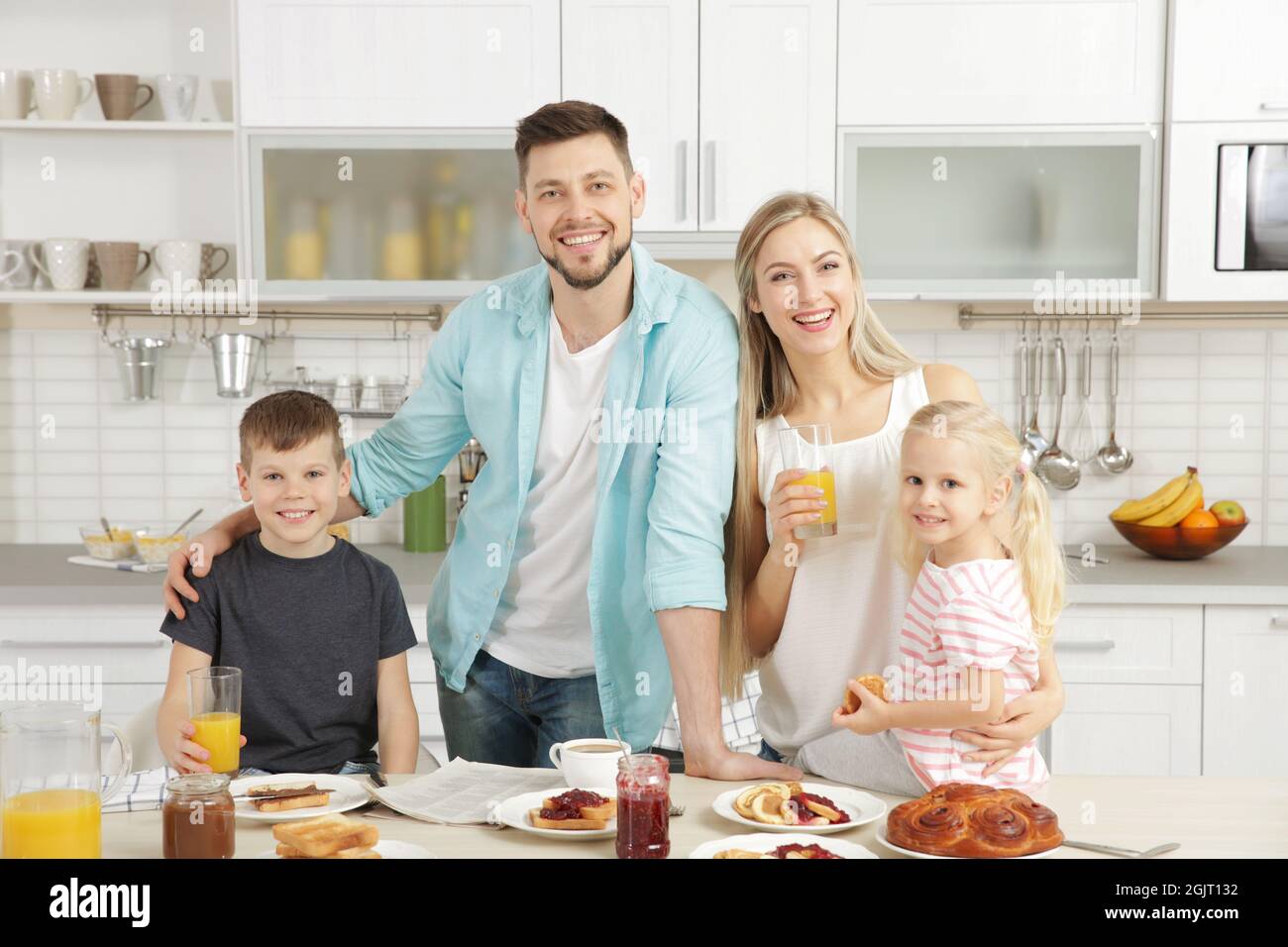 Happy family having breakfast on kitchen Stock Photo - Alamy