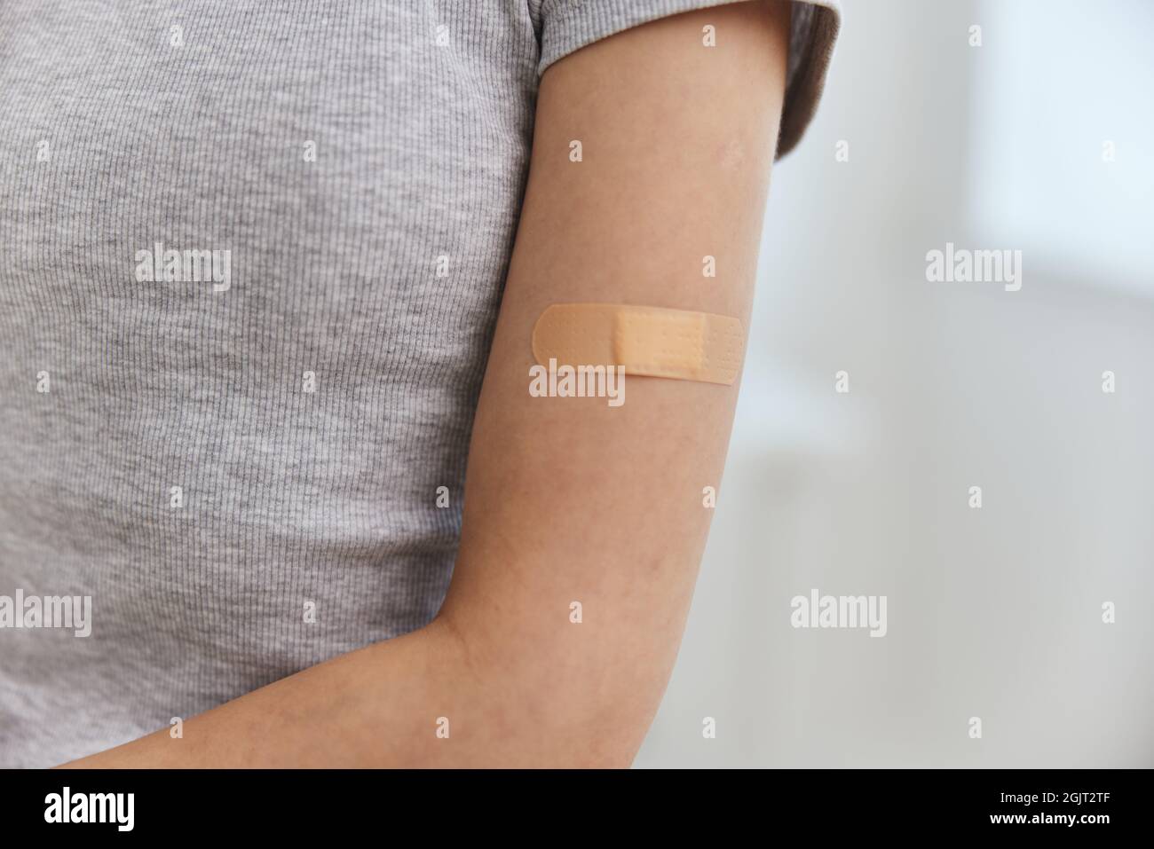 adhesive plaster on the shoulder female hand immunity vaccination ...
