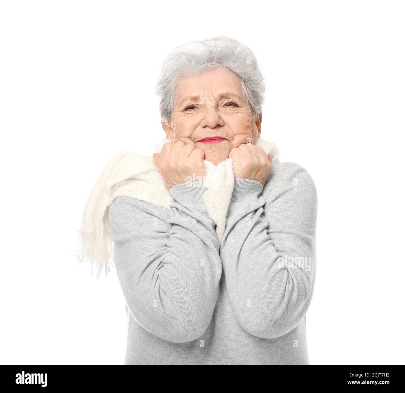 Portrait of elderly woman feeling cold on white background Stock Photo ...