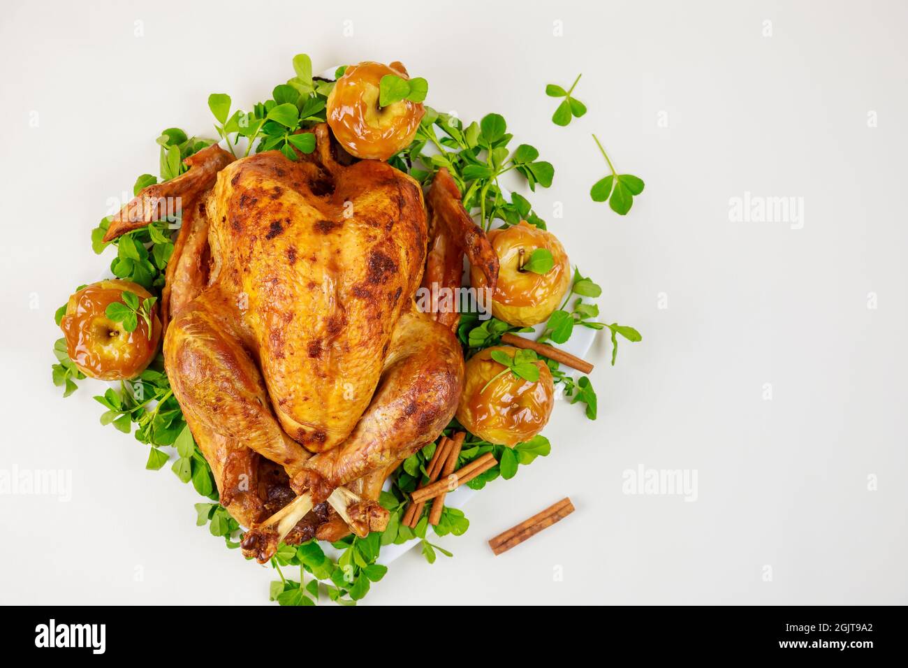 Grilled turkey garnished with caramel apples and clover leaves Stock ...