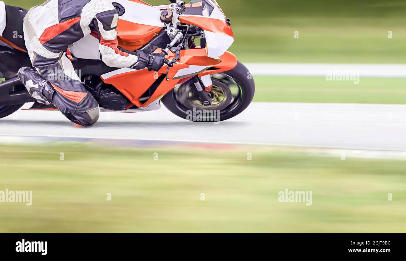 Motorcycle leaning into a fast corner on highway Stock Photo - Alamy