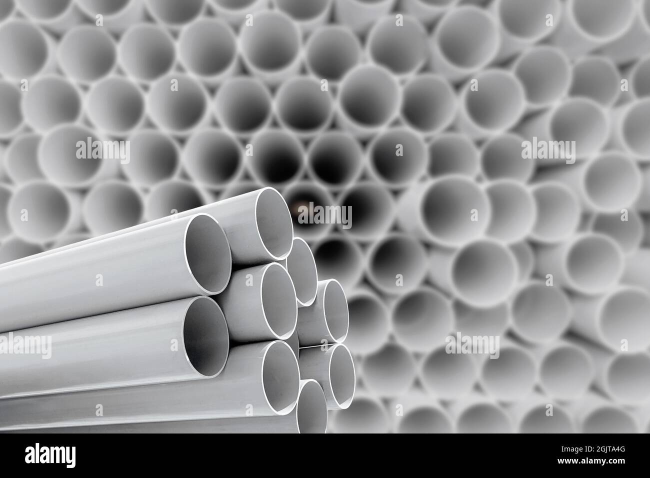 PVC pipes stacked in warehouse Stock Photo - Alamy