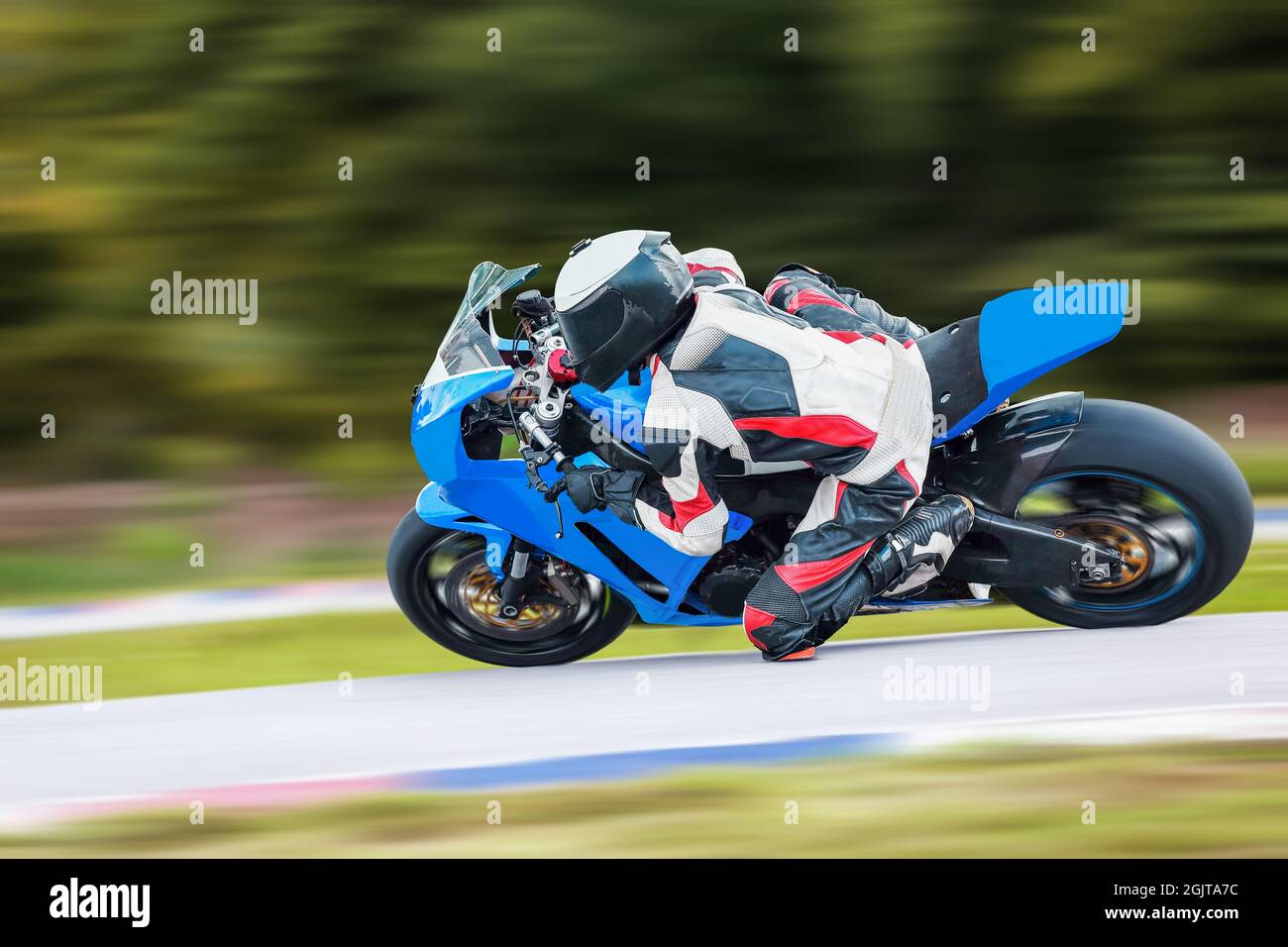Motorcycle leaning into a fast corner on highway Stock Photo - Alamy