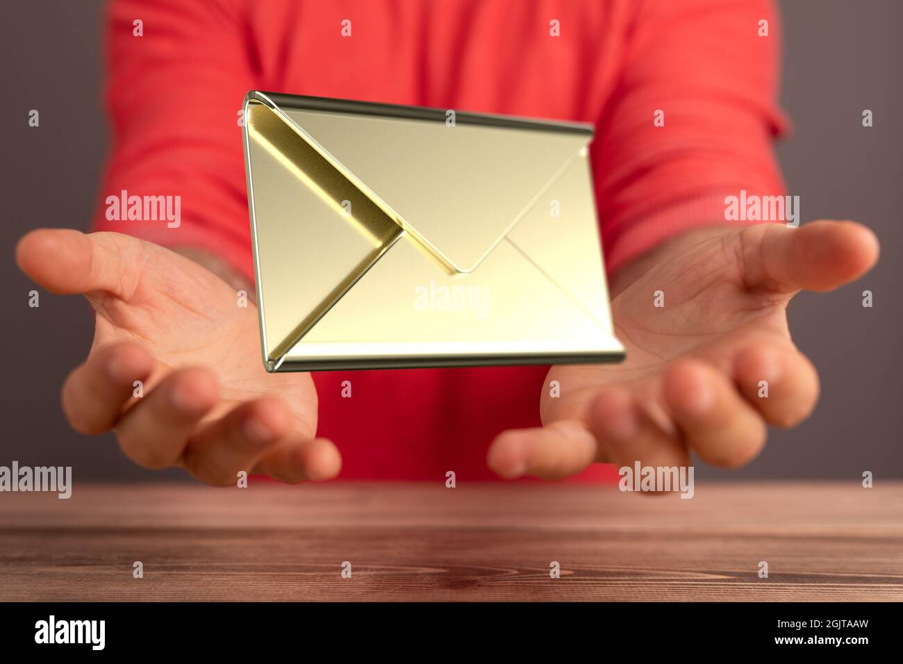 A person presenting the virtual projection of gold email inbox icon ...