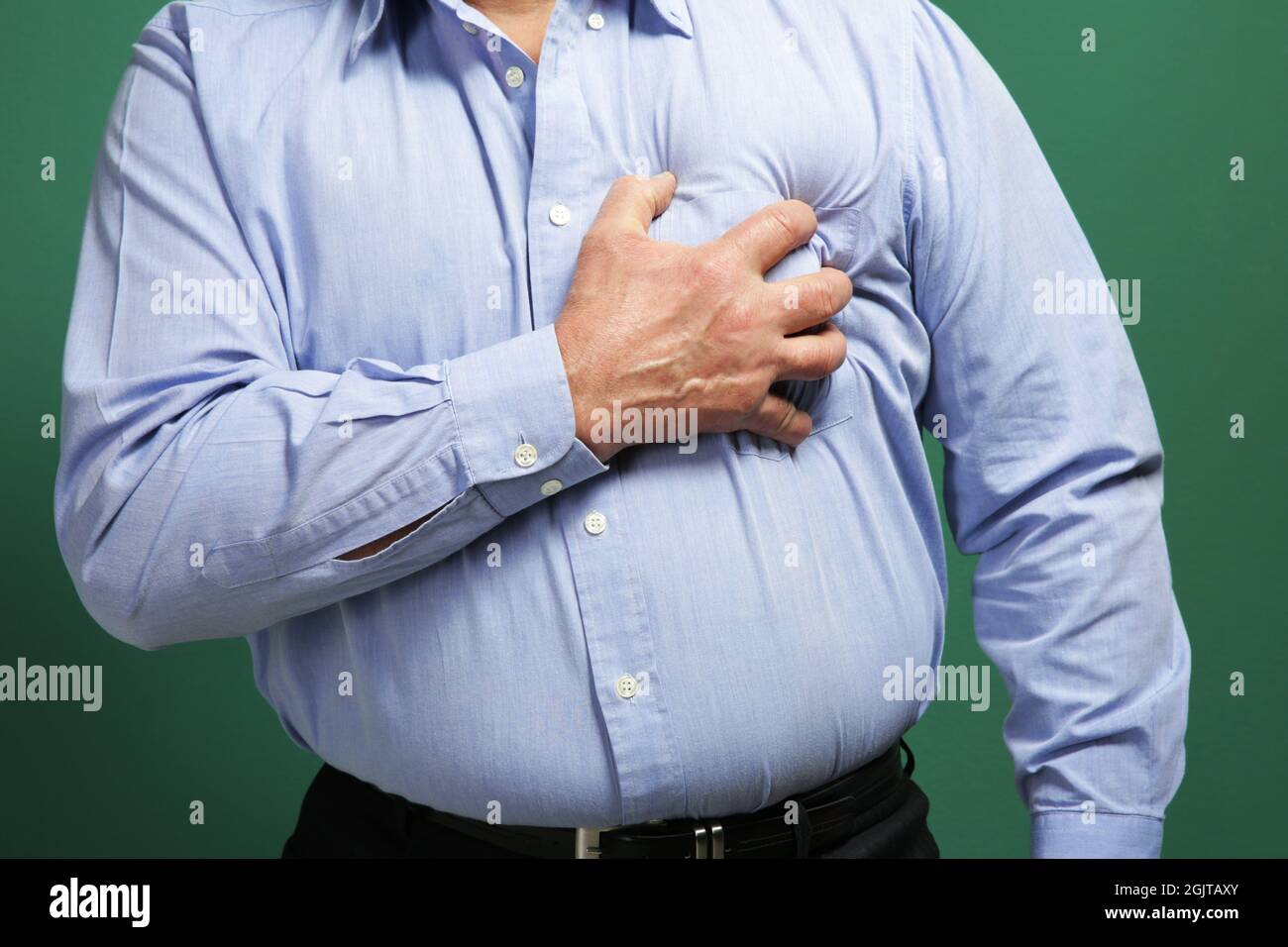 Man with chest pain suffering from heart attack on color background ...