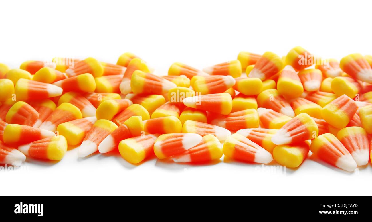 Colorful Halloween candy corns on white background Stock Photo - Alamy
