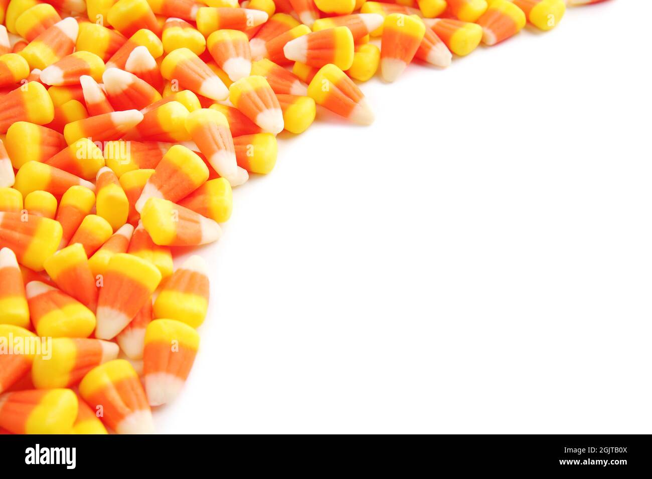Colorful Halloween candy corns on white background Stock Photo - Alamy