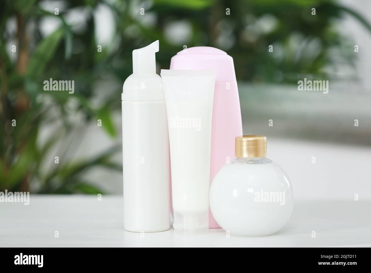 Cosmetic bottles on blurred background Stock Photo - Alamy