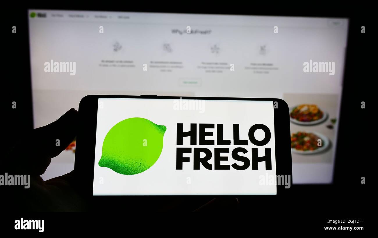 Person holding smartphone with logo of German meal-kit company ...