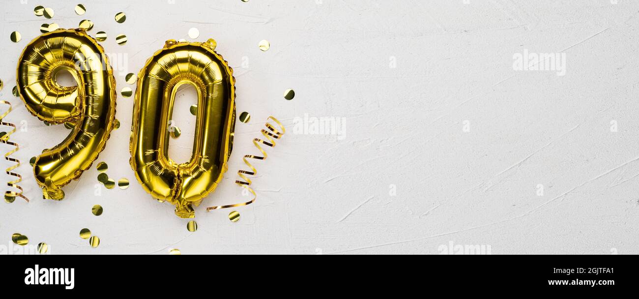 golden foil balloon number ninety. Birthday or anniversary card with the inscription 90. gray ...