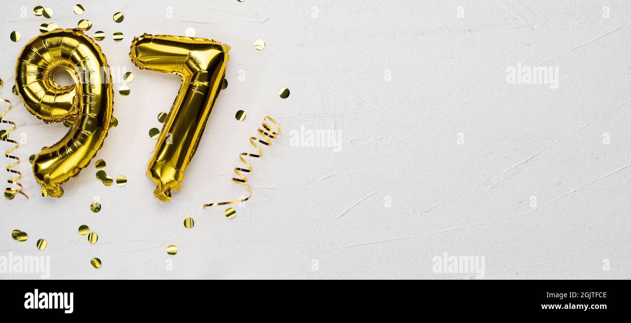golden foil balloon number ninety seven. Birthday or anniversary card with the inscription 97 ...
