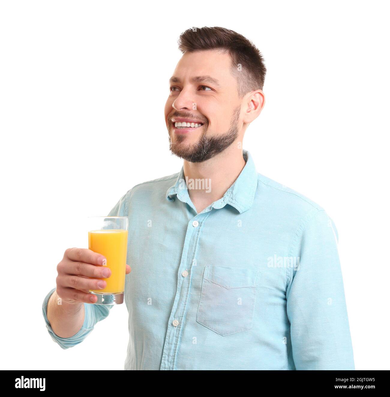 Handsome man posing with juice on white background Stock Photo - Alamy