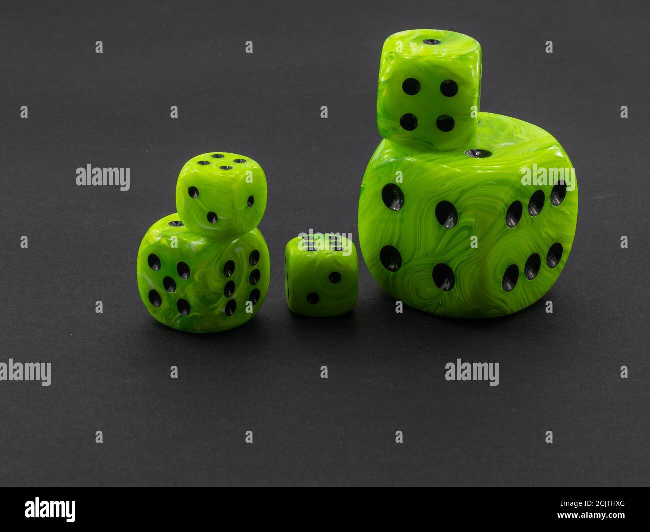 green dice scattered on dark background Stock Photo - Alamy